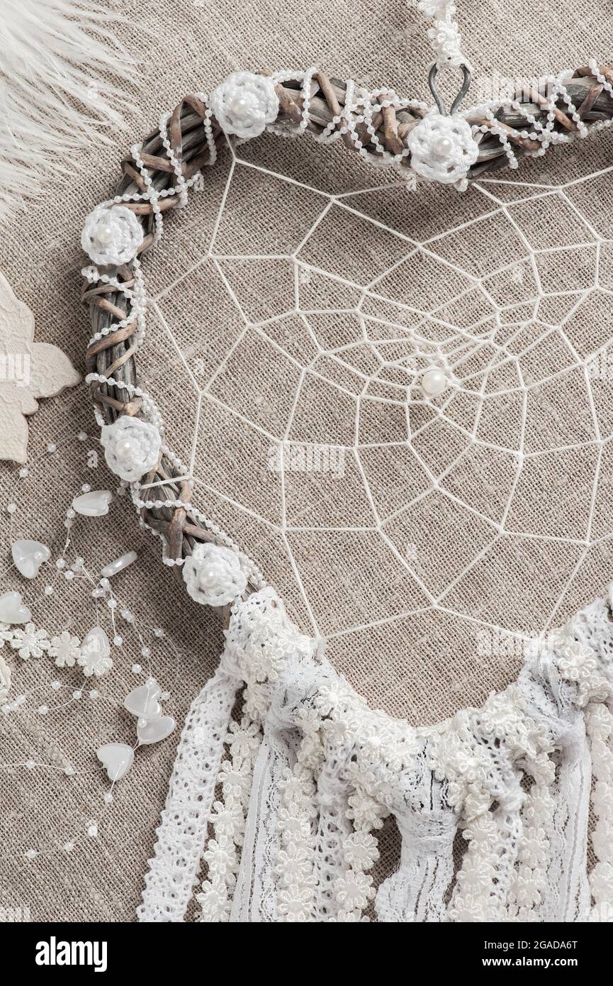 Dream catcher shaped heart with white laces and pearls in the interior ...