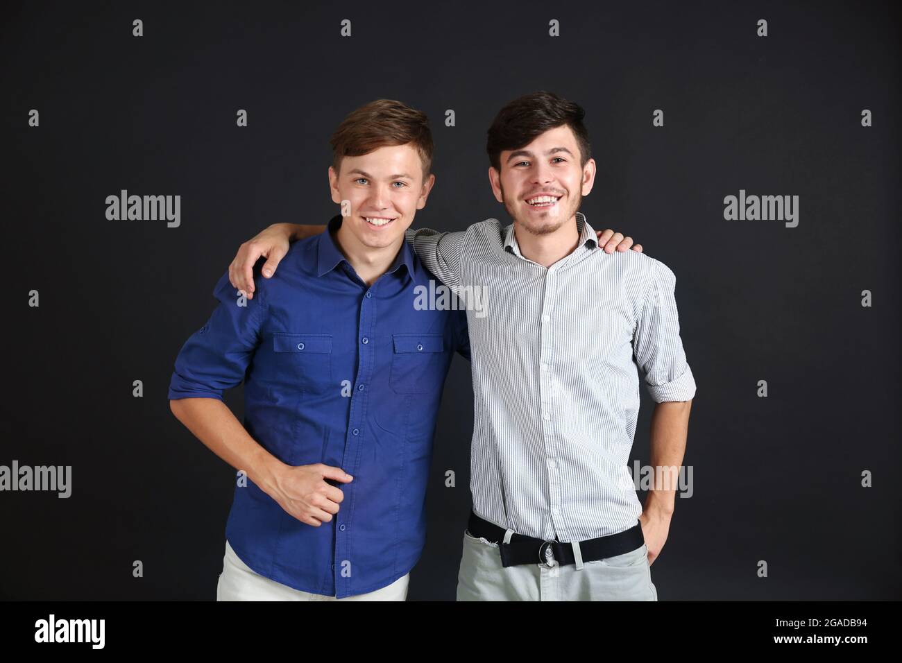 Two brothers on dark background Stock Photo - Alamy
