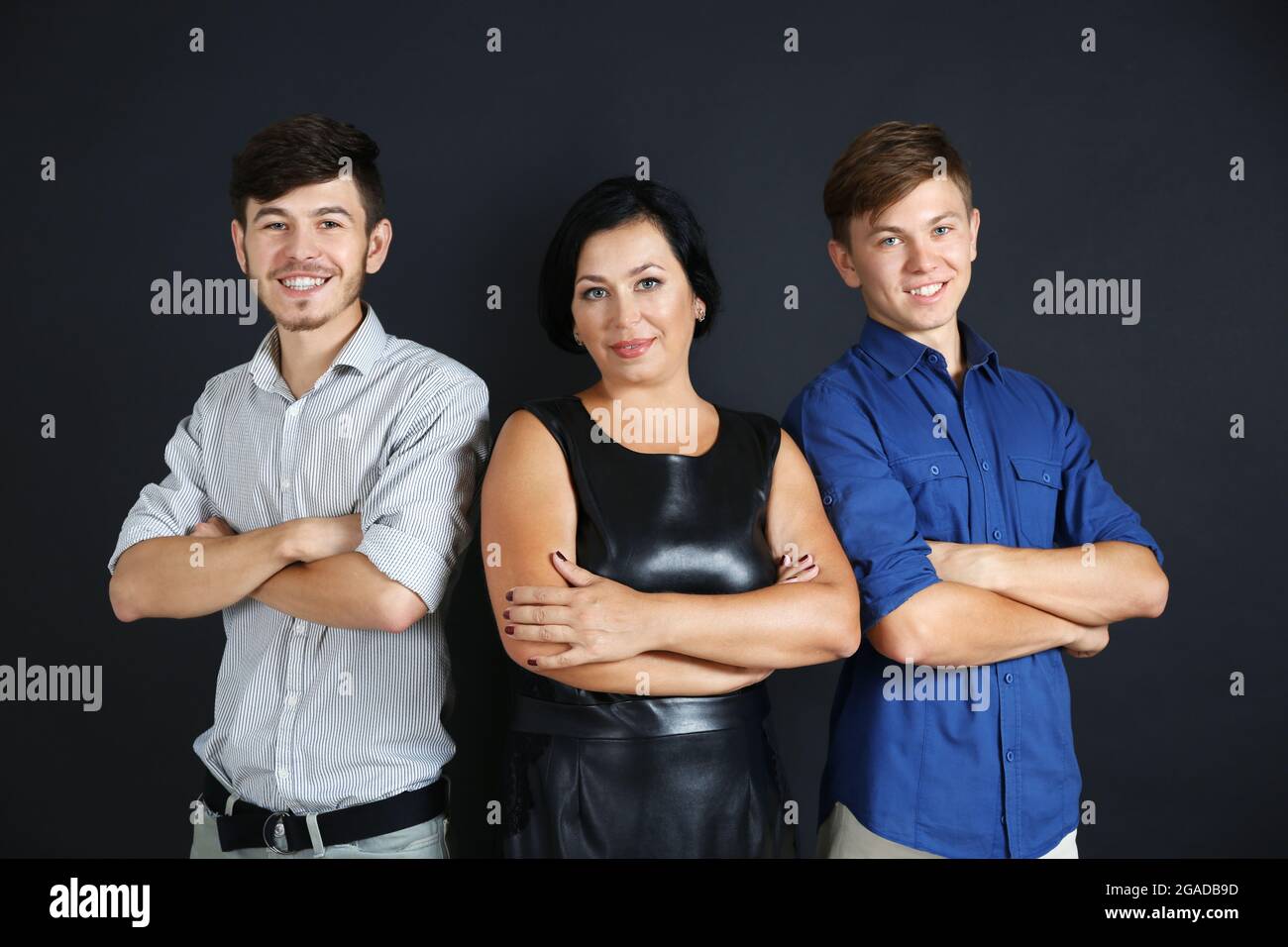 Portrait of mother and her sons on dark background Stock Photo - Alamy