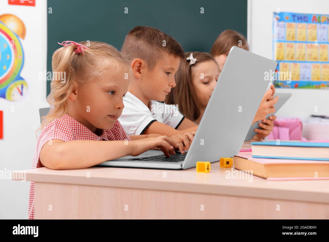 Group of children at laptop in the classroom Stock Photo - Alamy