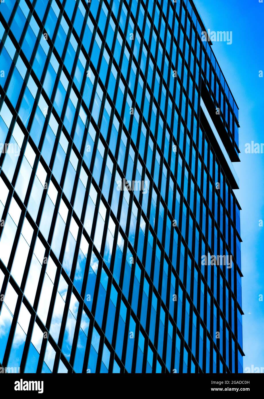 Vertical shot of a bright blue glass building exterior design Stock ...