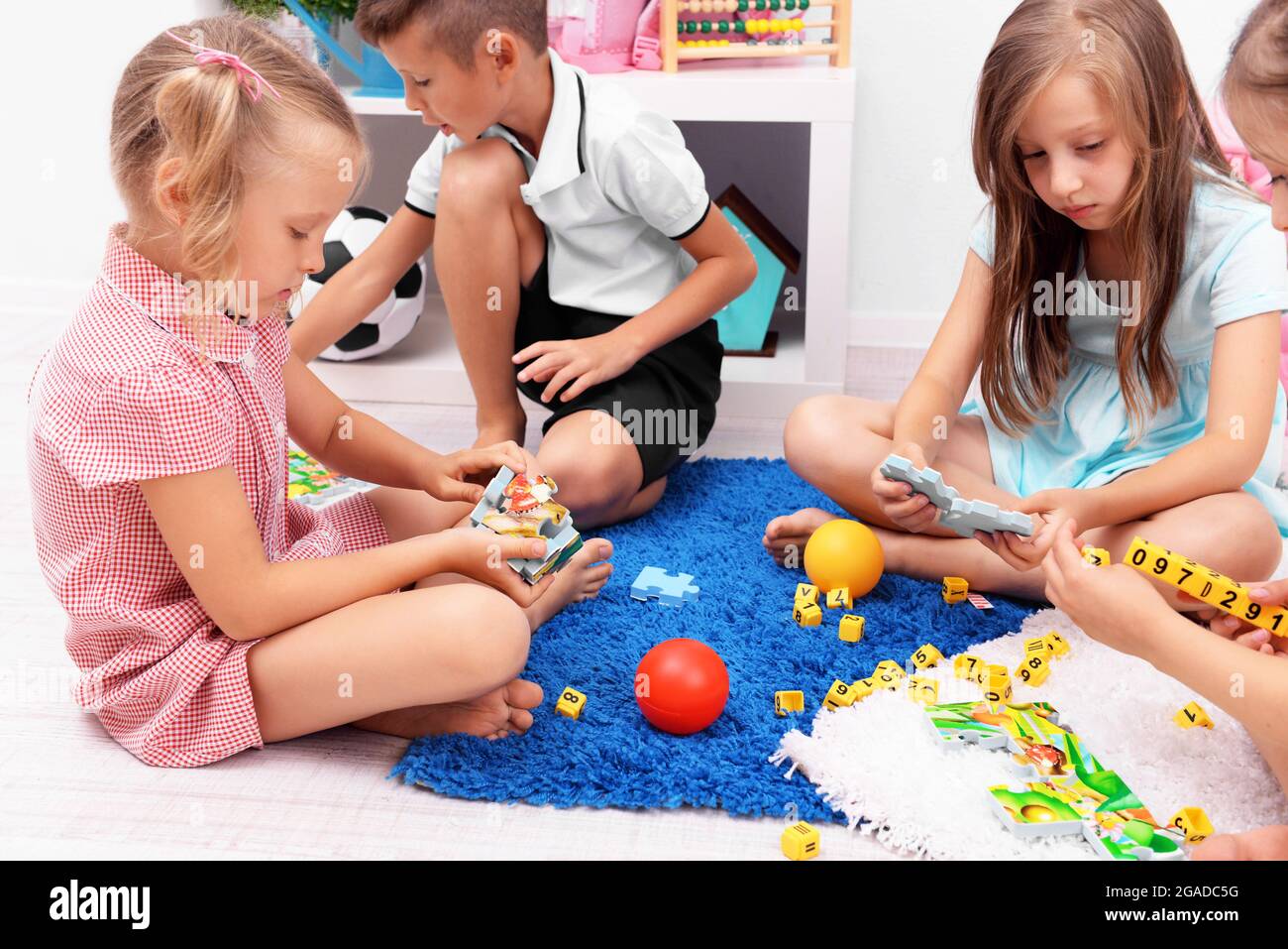Group of children playing on floor in classroom Stock Photo - Alamy