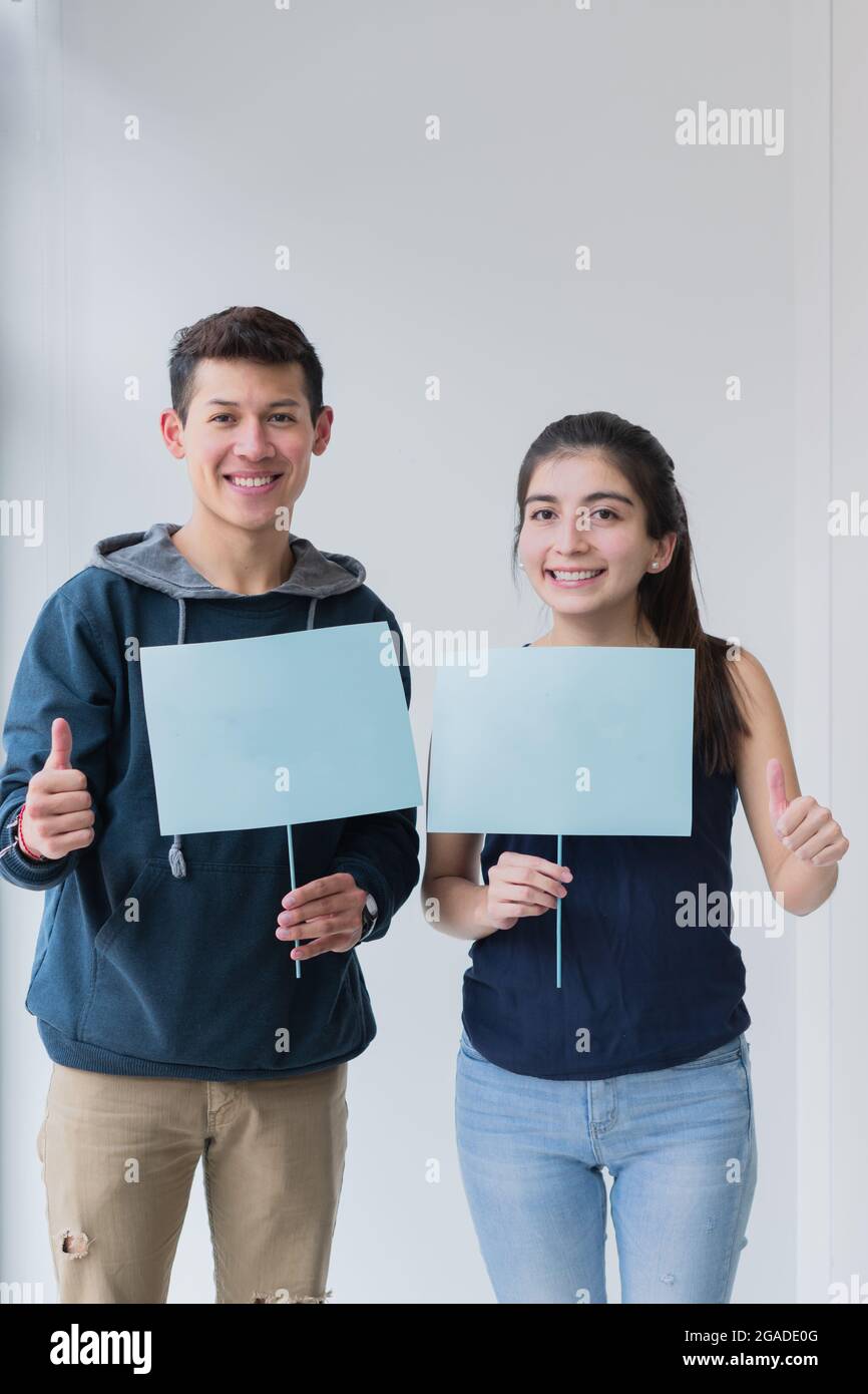 Happy young people with a poster in their hands showing their approval ...