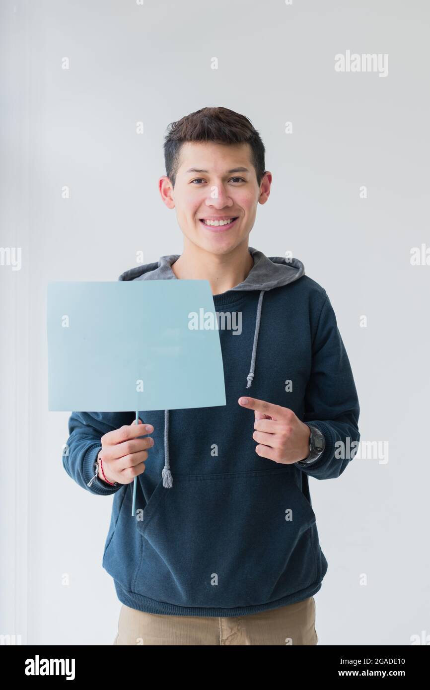 Very happy young man with a poster in hand showing his approval and ...