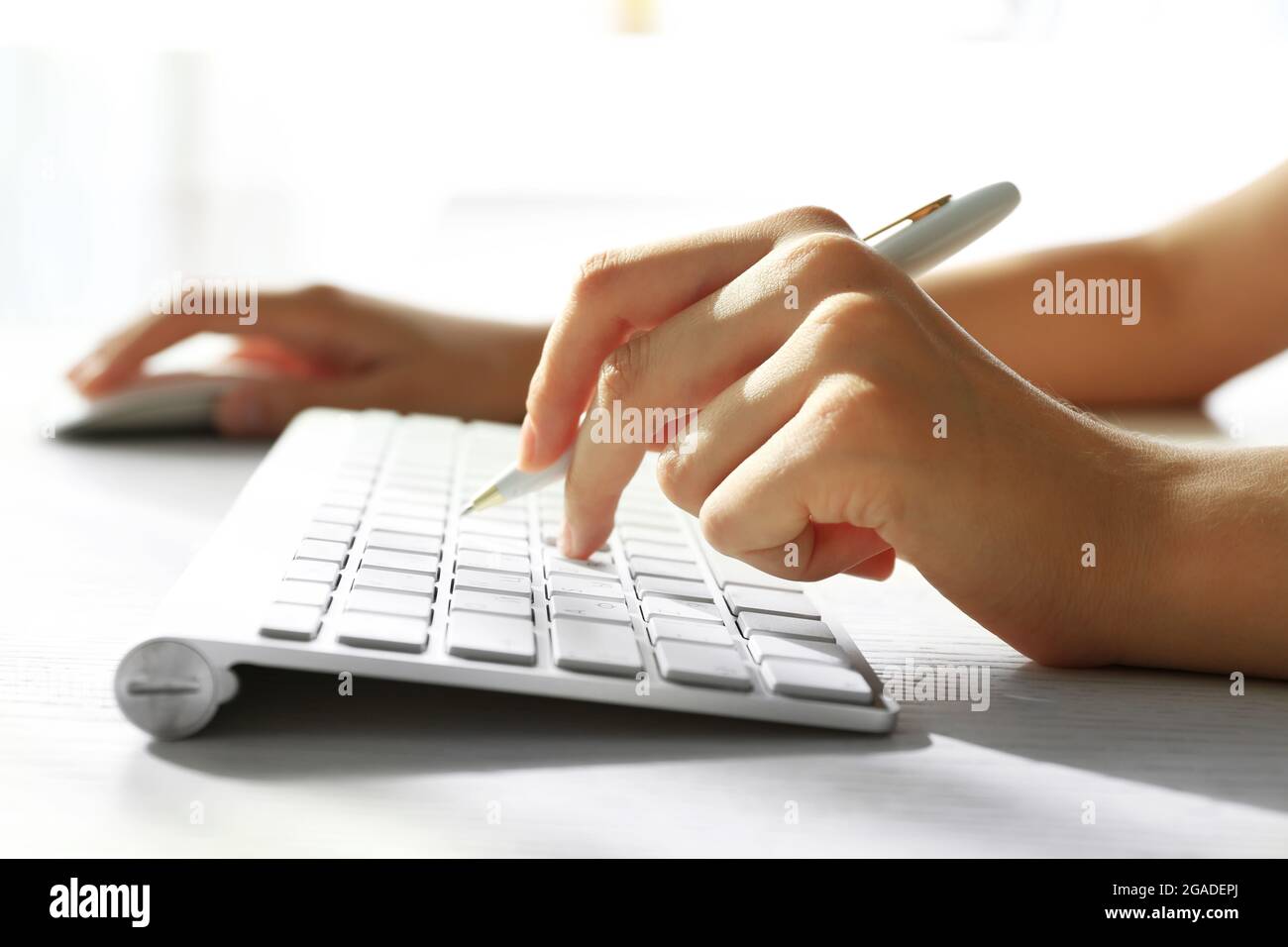 Female hand with pen typing on keyboard at table, closeup Stock Photo ...