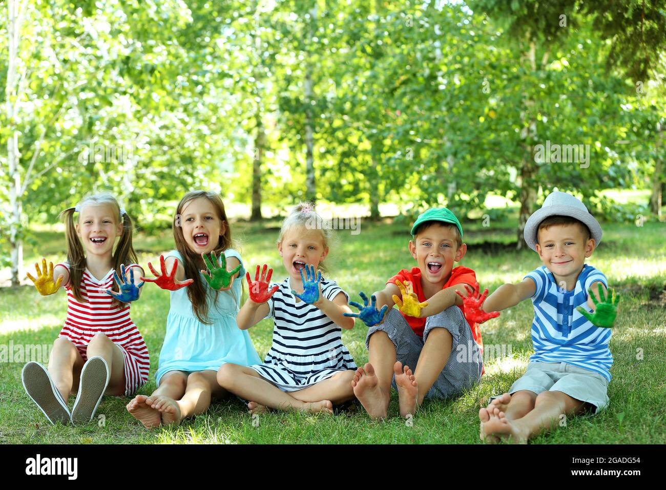 Happy active children with bright colored palms in park Stock Photo - Alamy