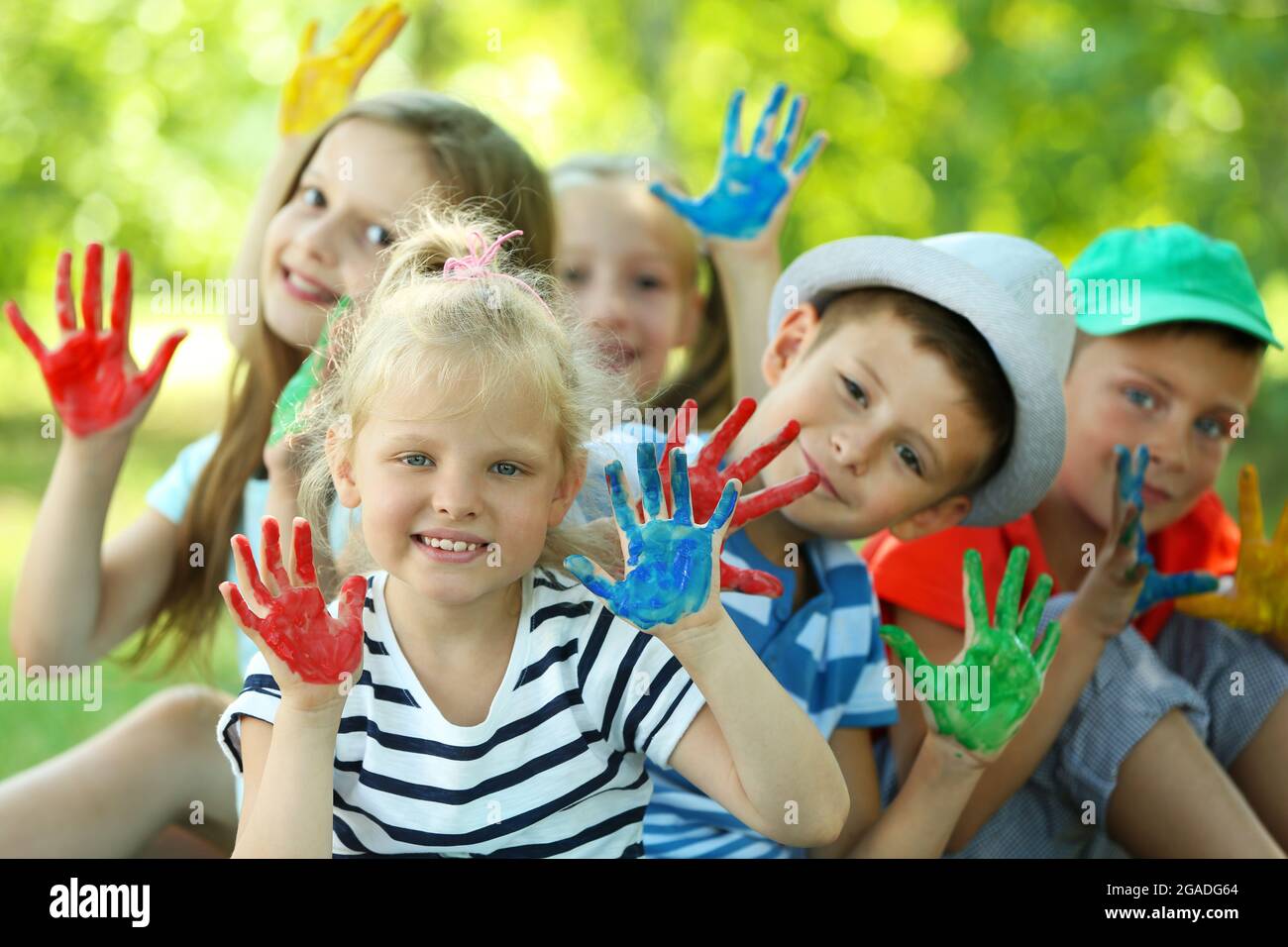 Happy active children with bright colored palms in park Stock Photo - Alamy