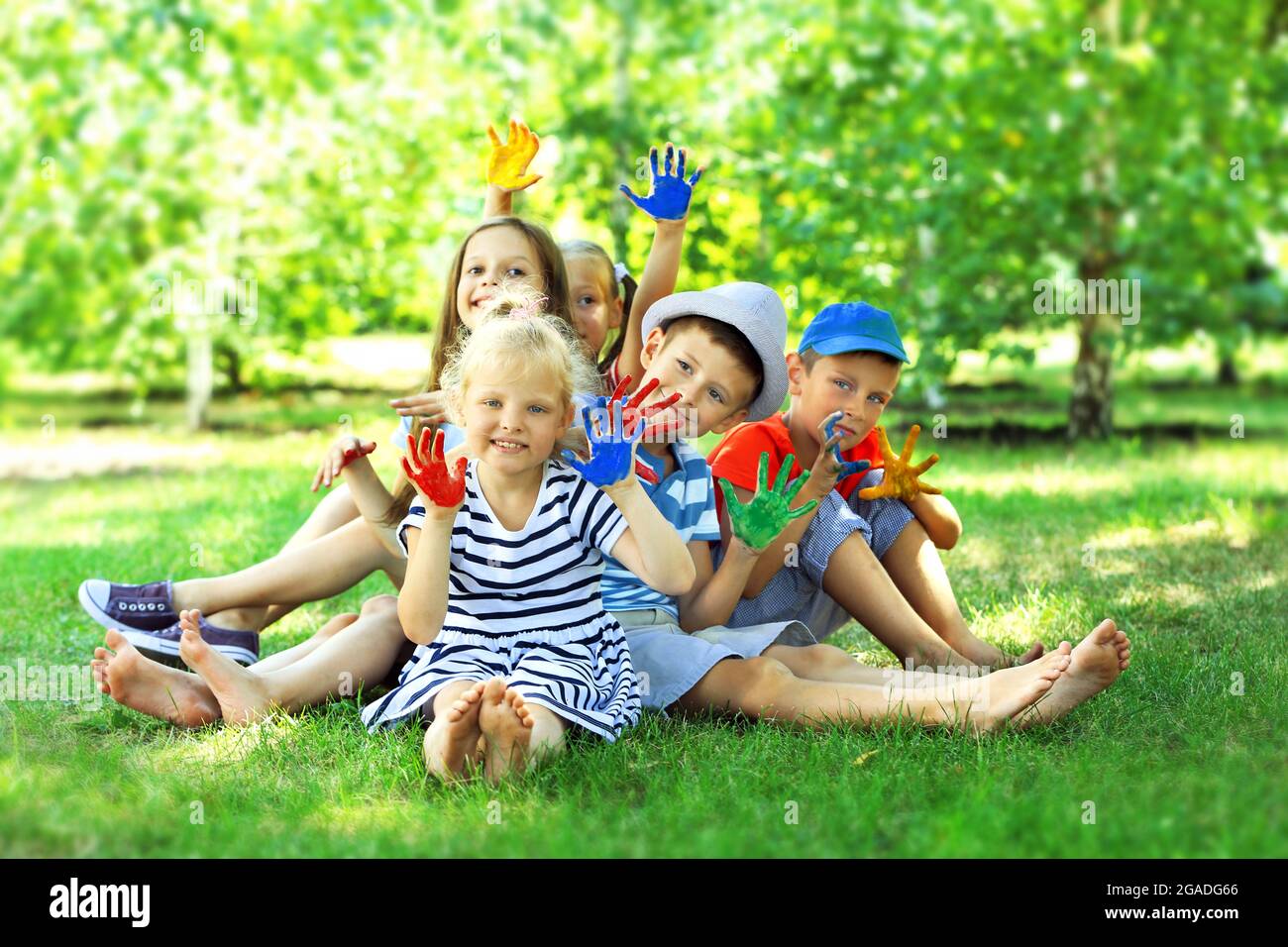 Happy active children with bright colored palms in park Stock Photo - Alamy
