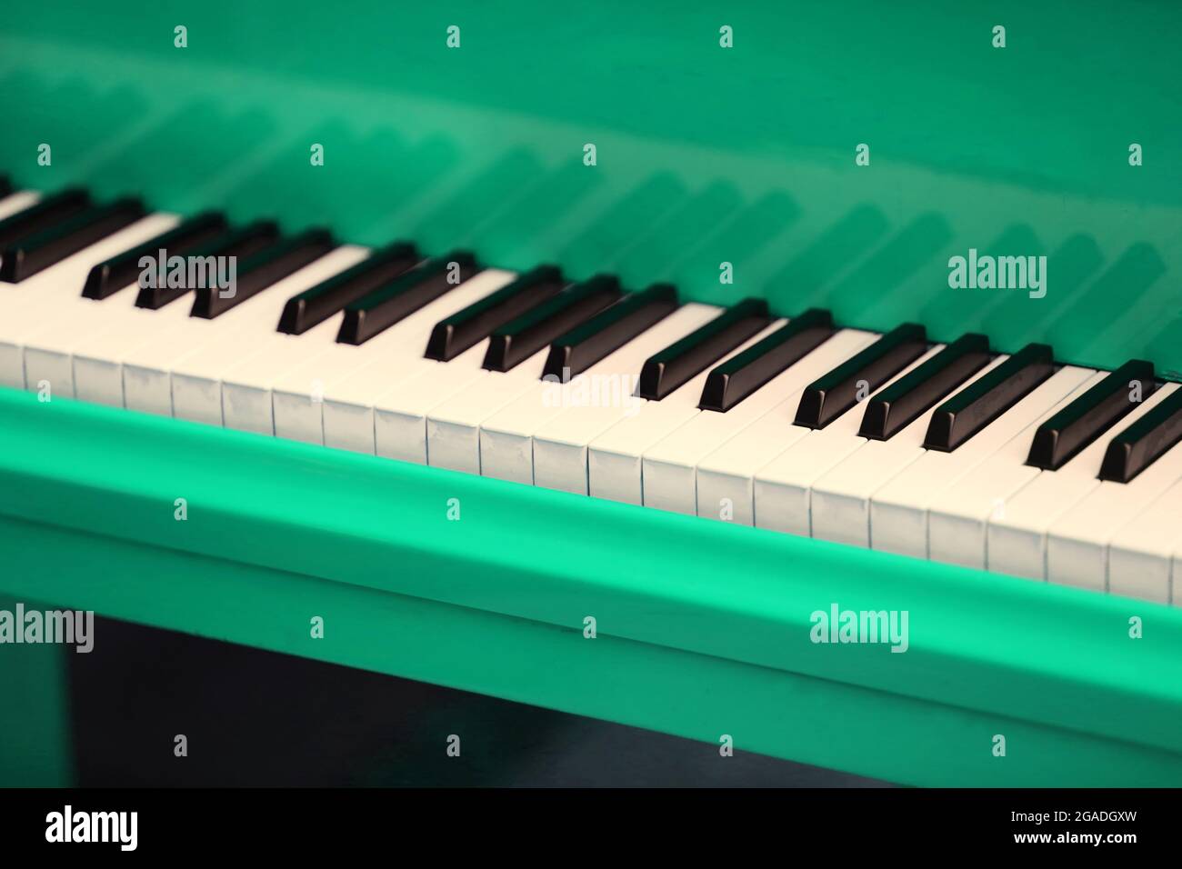 Piano keys of green piano close up Stock Photo - Alamy