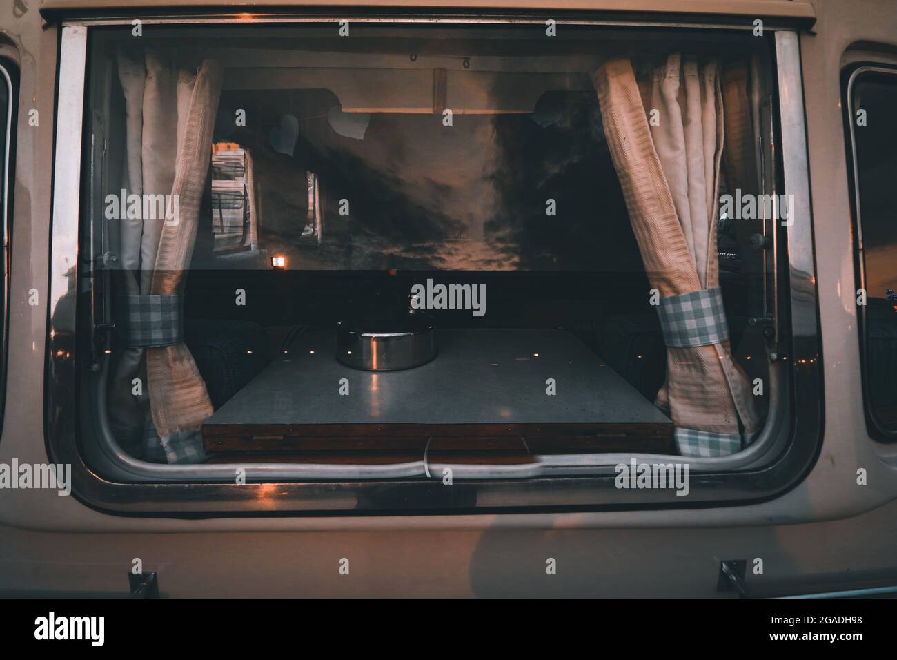View inside a vintage cute bus through a small window with curtains ...