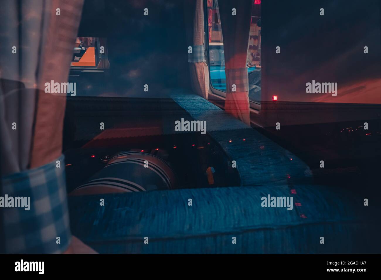 View inside a vintage cute bus through a small window with curtains ...