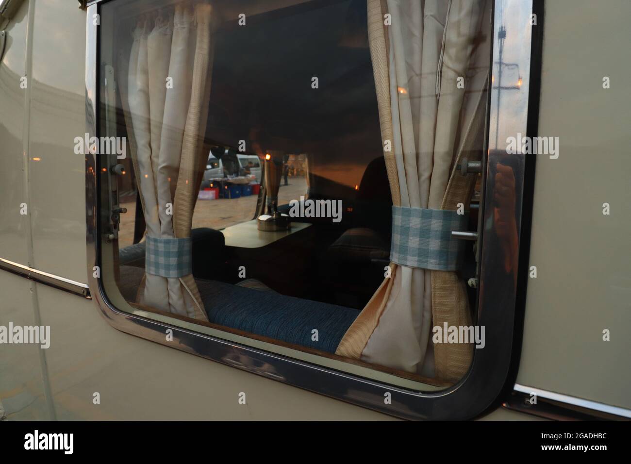 View inside a vintage cute bus through a small window with curtains ...