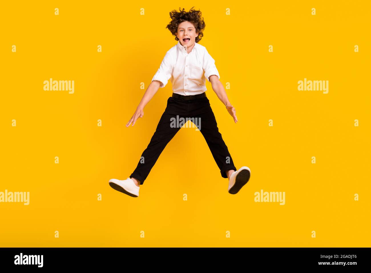 Full length photo of funny small brunet boy jump wear uniform isolated ...