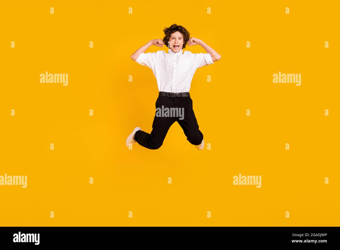 Full length photo of impressed small brunet boy jump wear uniform shoes ...