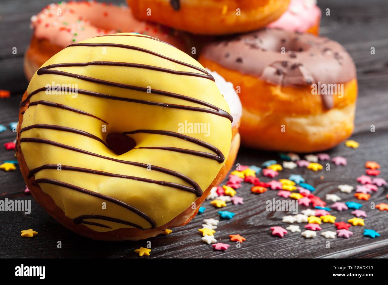 Glazed colored donuts background image. Macro shot Stock Photo - Alamy