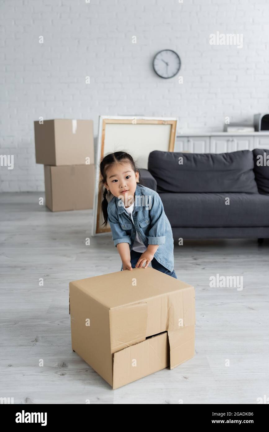 asian toddler girl pushing carton box in new home Stock Photo - Alamy