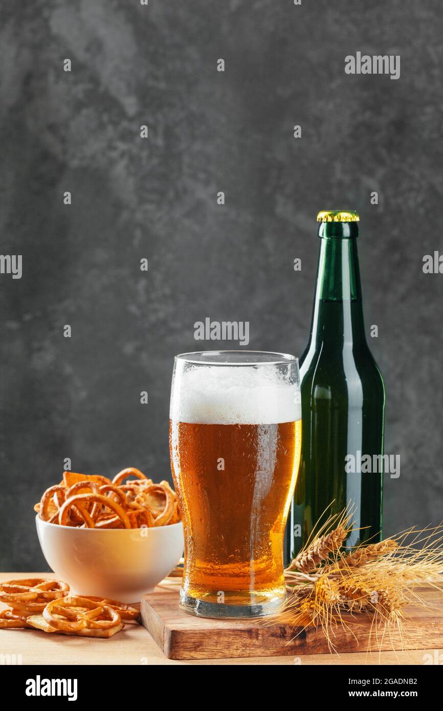 Lager beer and snacks on stone table. Cracker, chips side view Stock ...