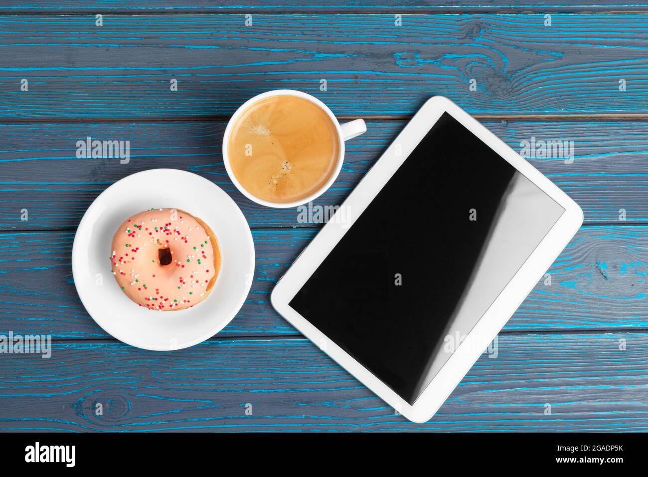 Coffee break relax concept, A cup of coffee, donut and tablet on table ...
