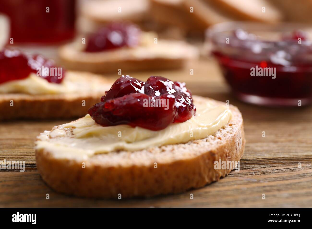 Fresh toast with butter and jam on table close up Stock Photo - Alamy