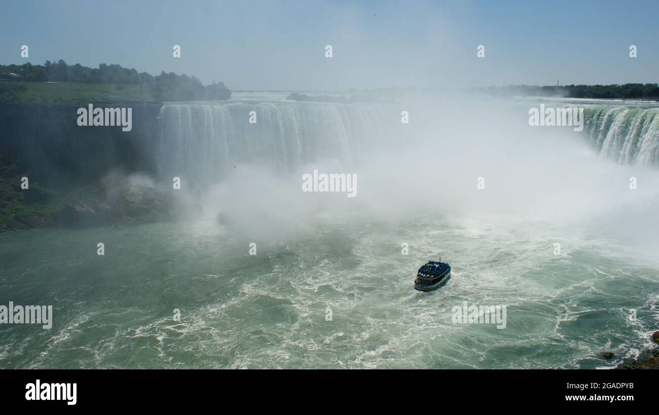 Shot of the boat floating near the Niagara waterfalls in Canada as a ...