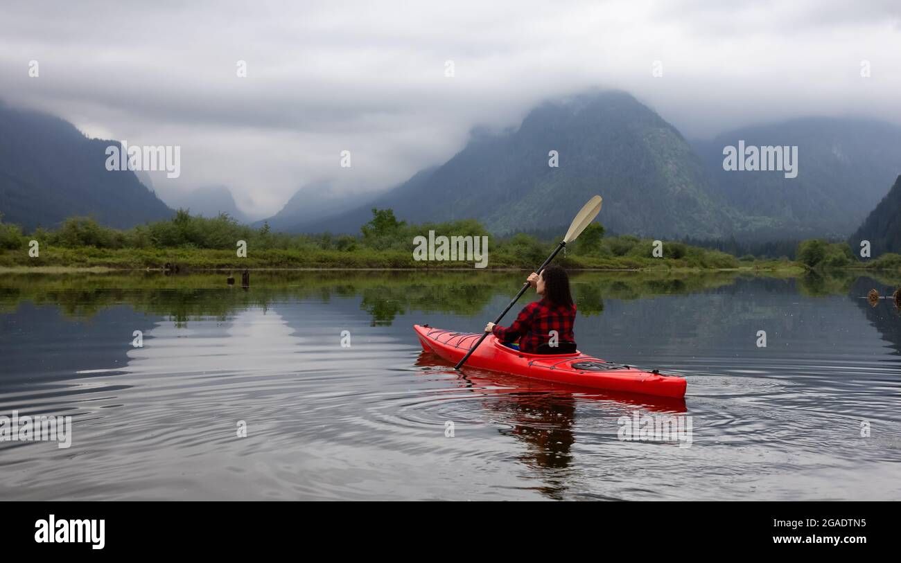 Adventure Caucasian Adult Woman Kayaking in Red Kayak Stock Photo - Alamy