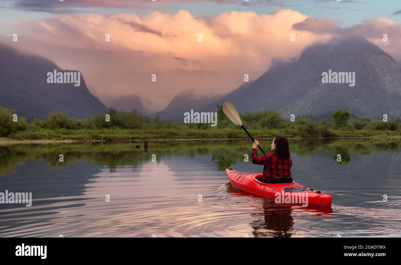 Adventure Caucasian Adult Woman Kayaking in Red Kayak Stock Photo - Alamy