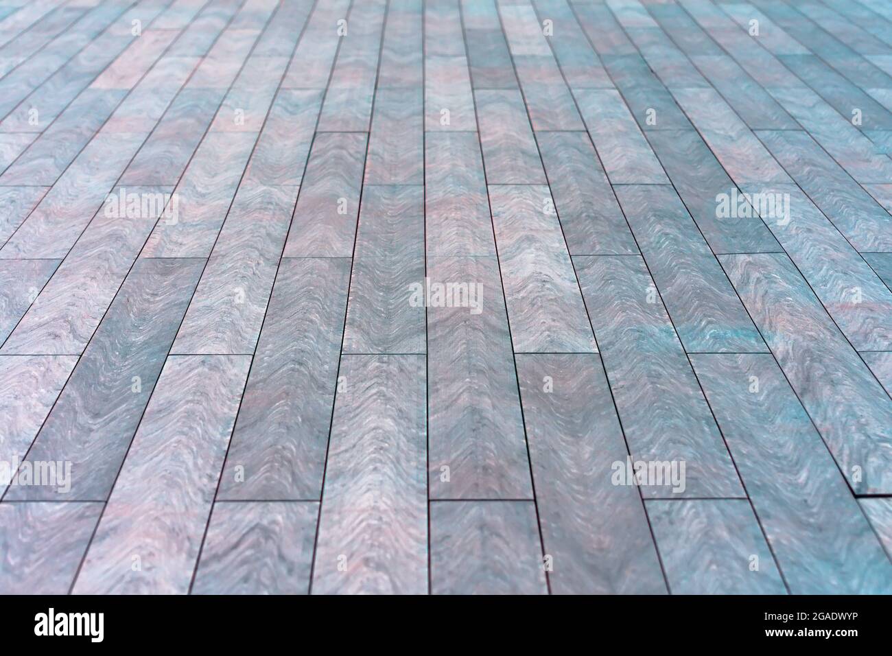 The surface with elongated rectangular stone tiles goes into ...