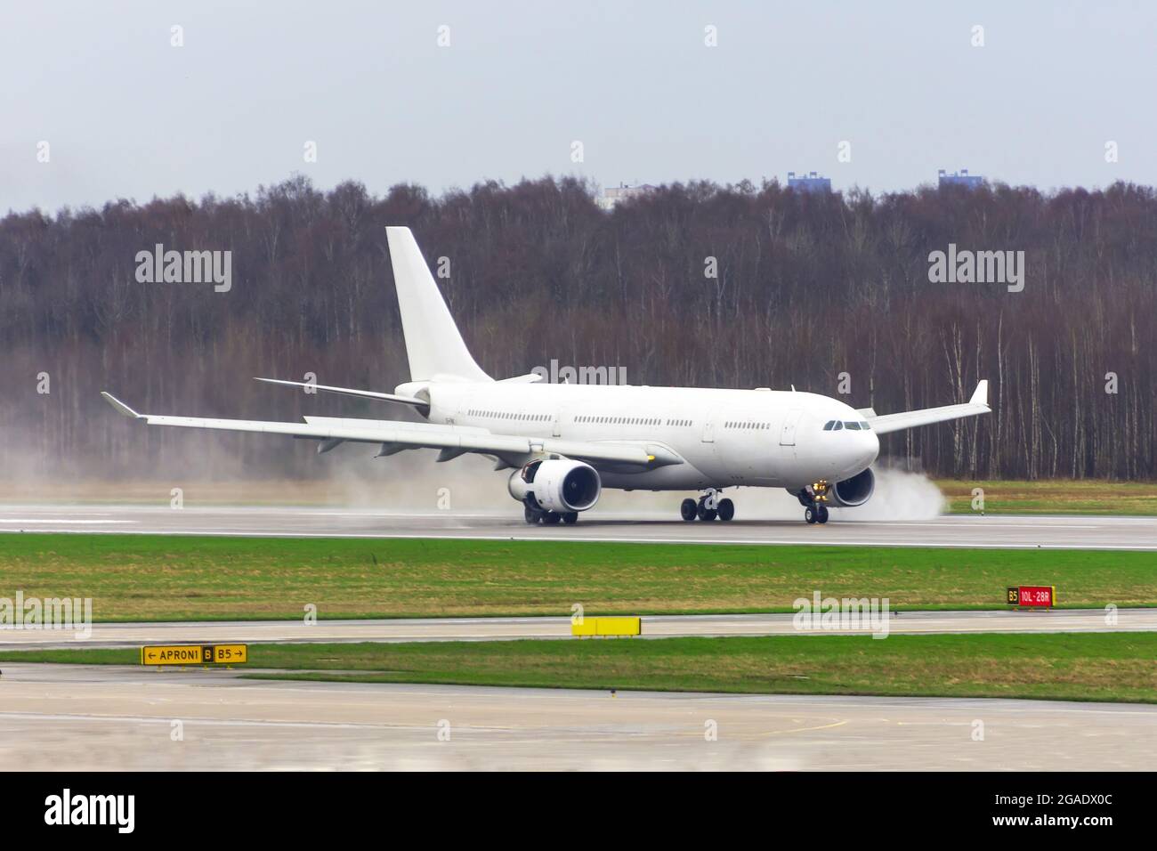 Airplane landed on a wet runway at the airport Stock Photo - Alamy