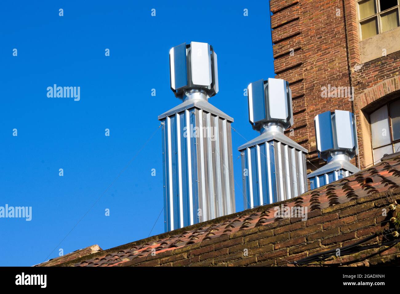 New steel chimneys on an old industrial environment, blue sky Stock ...