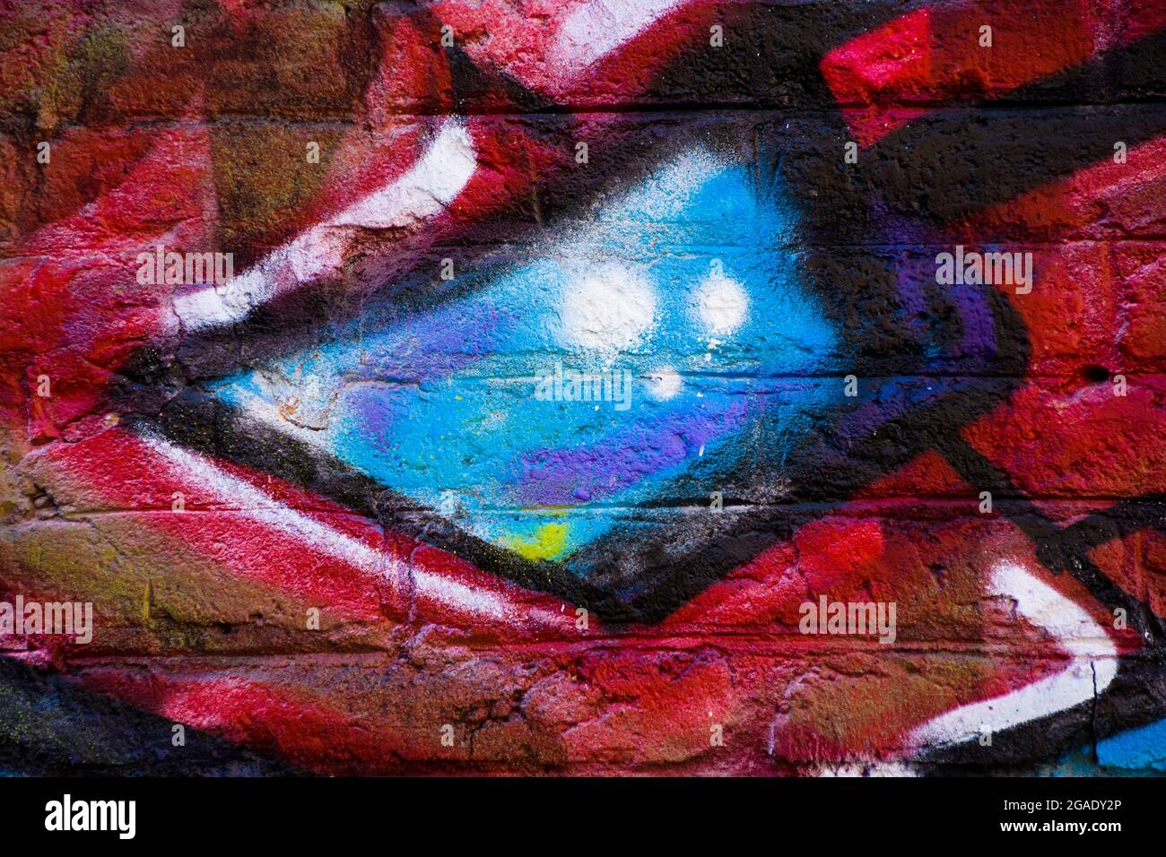 Abstract red, blue and black graffiti on a brick wall Stock Photo - Alamy