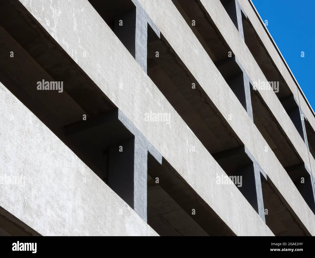 Facade of a multi-level car parking on a background of blue sky Stock ...