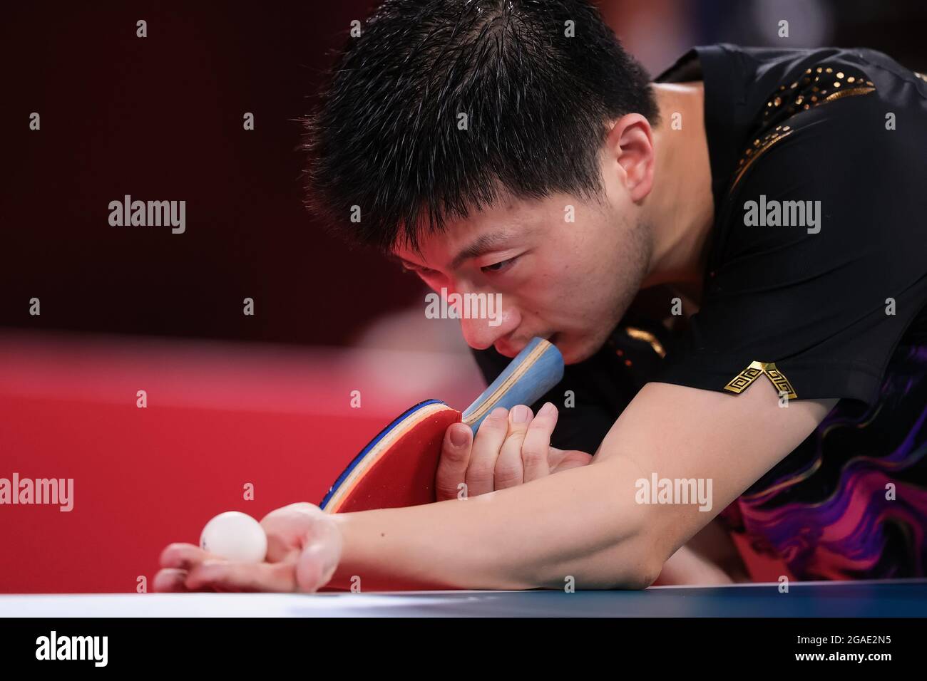 Tokyo, Japan. 30th July, 2021. Ma Long serves during the Men's Table ...