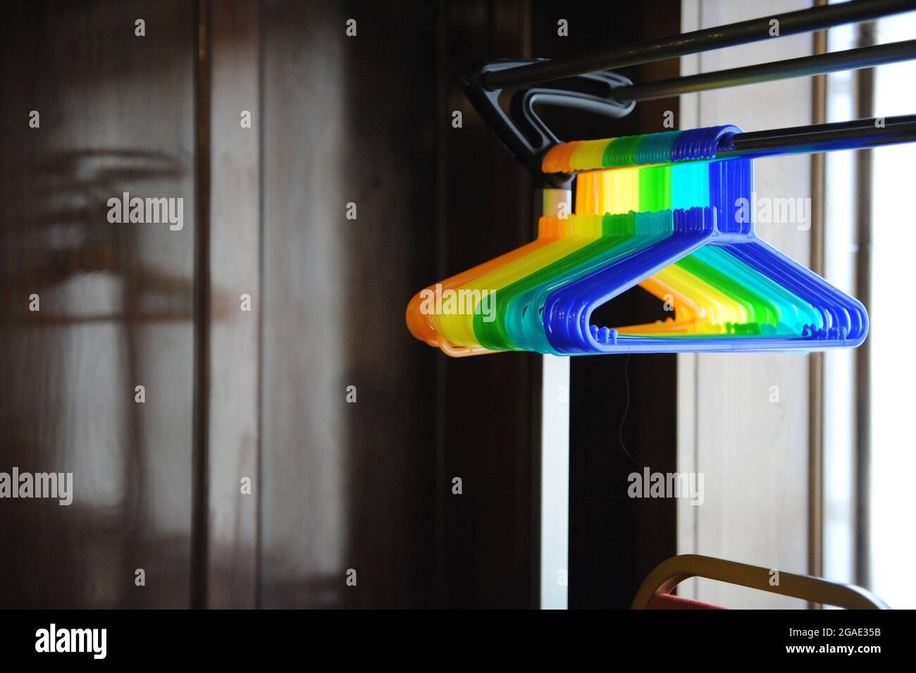 Dazzling, vibrant colours of empty plastic coat-hangers on a rack Stock ...