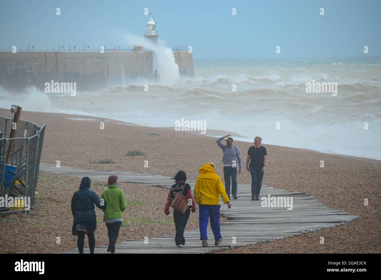 walkers struggle against a powerful wind caused by storm evert. uk ...