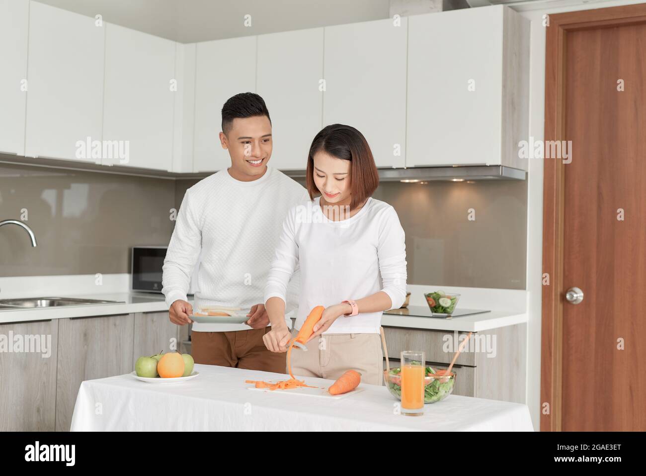 Happy smiling family couple cooking on loft kitchen Stock Photo - Alamy