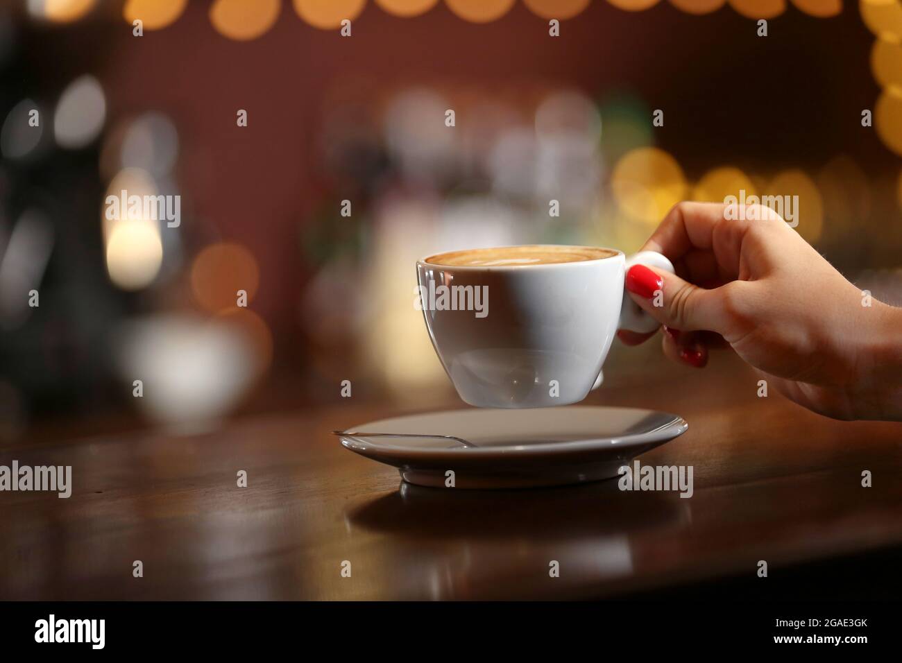 Female hand with cup of cappuccino on bar background Stock Photo - Alamy