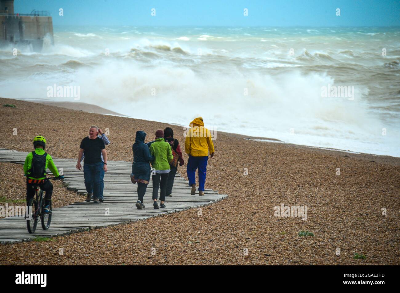 walkers struggle against wind Stock Photo - Alamy