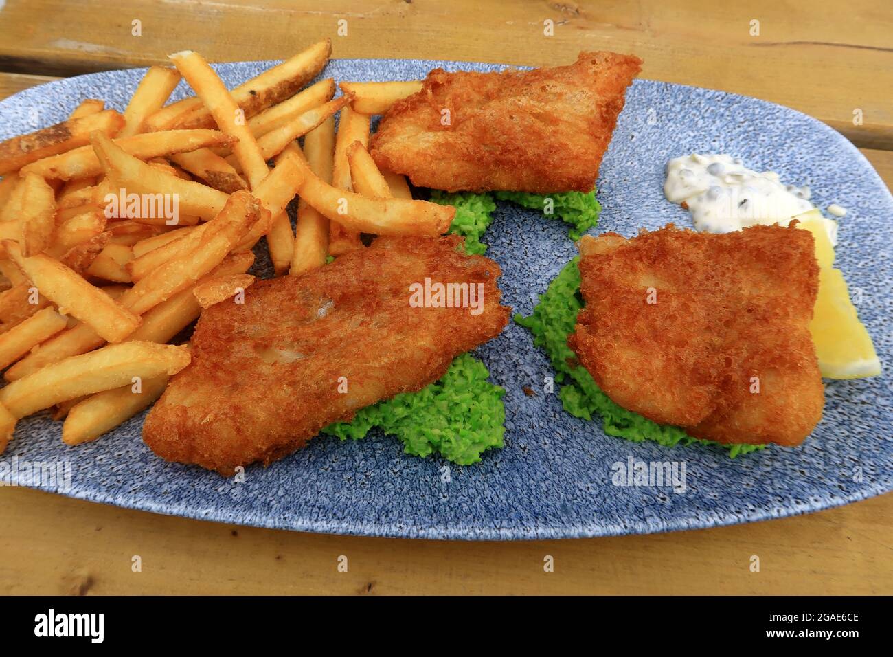 A plate full of Cod and crispy french fries Stock Photo - Alamy