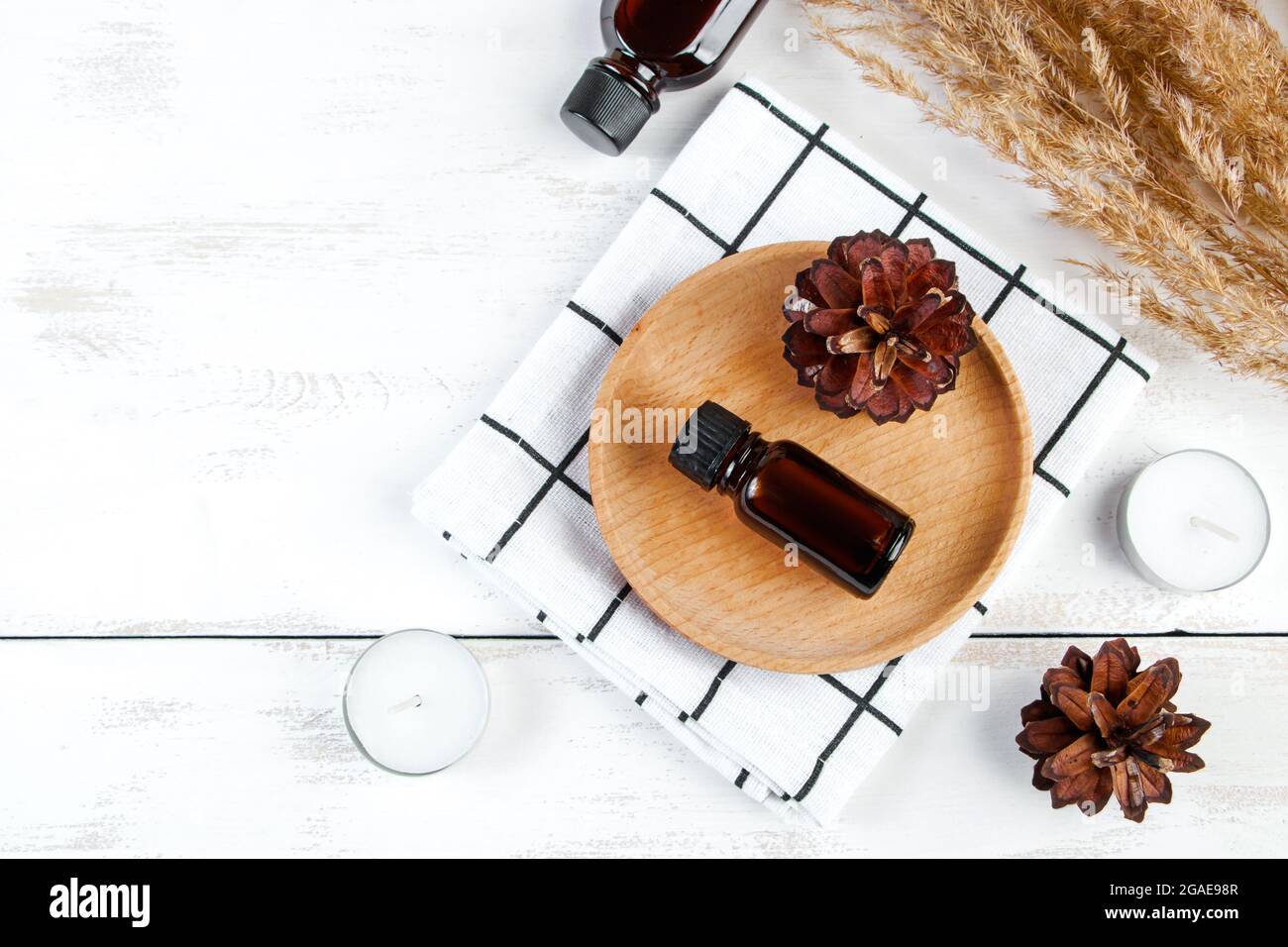 Autumn skin care concept. Bottle of pine essential oil on a white ...