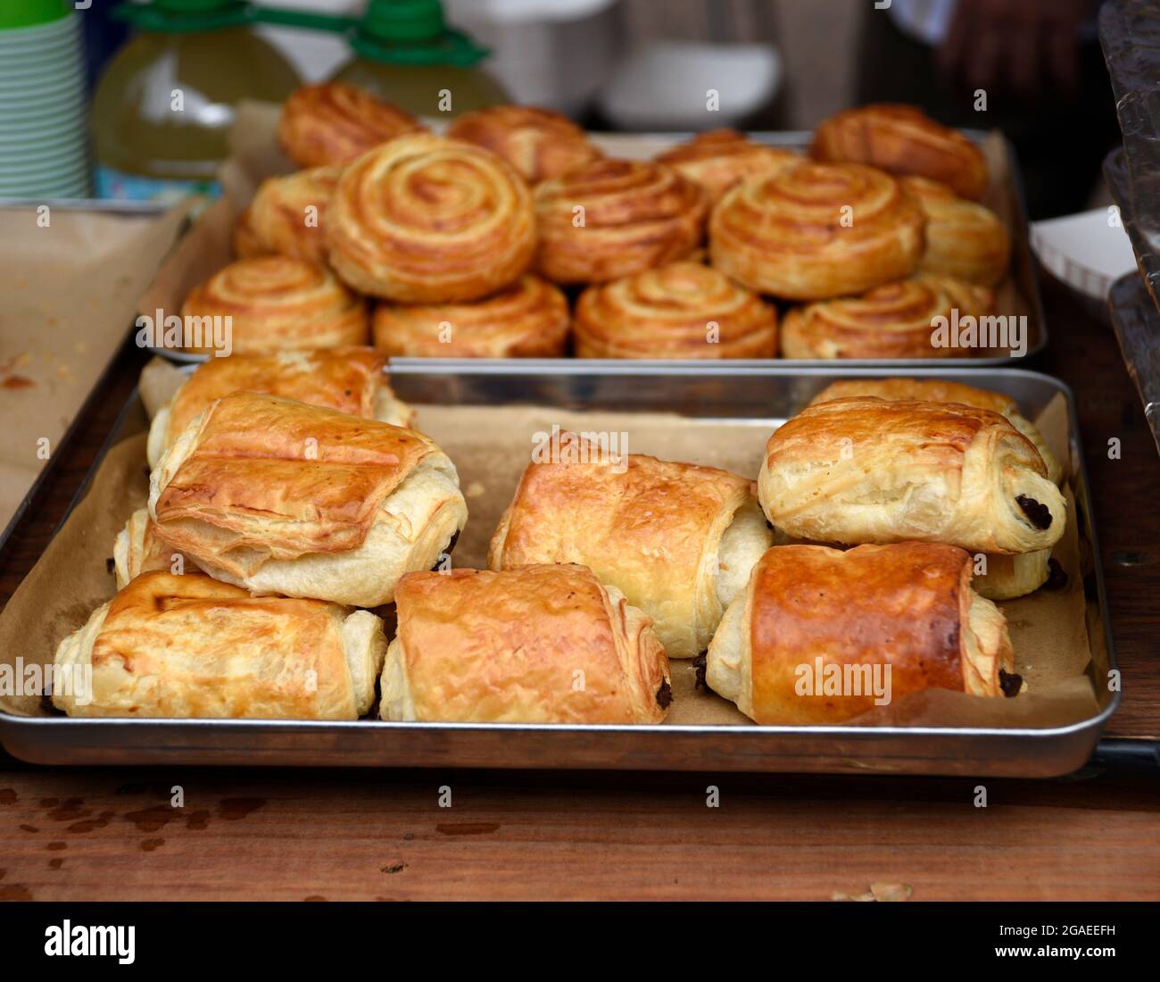 An outdoor food booth serves chocolate filled croissants and other ...