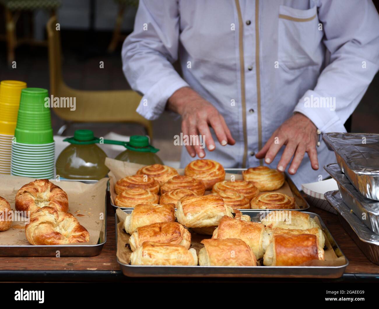 An outdoor food booth serves chocolate filled croissants and other ...