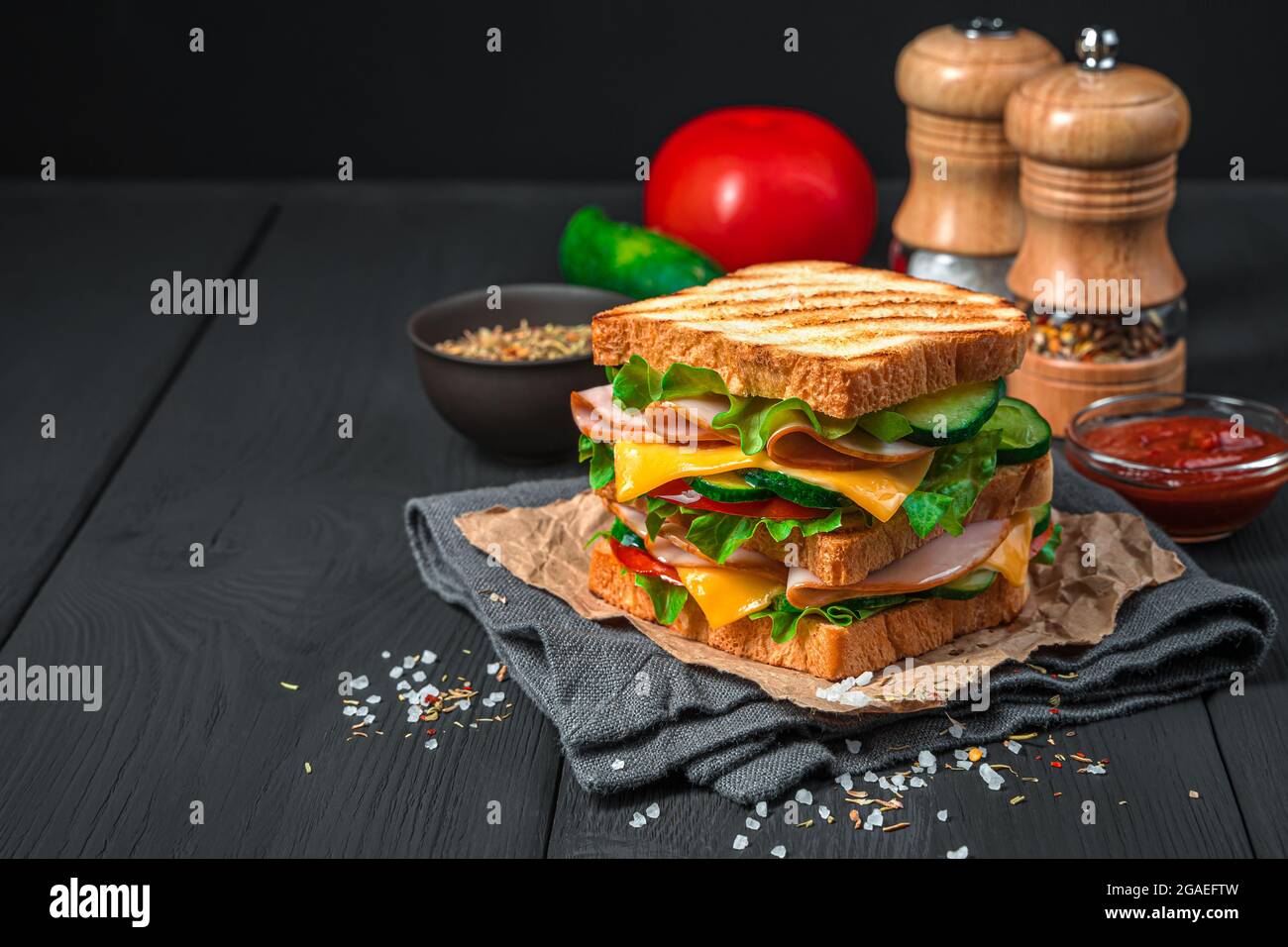 Double sandwich with grilled toast, ham, vegetables and cheese on a ...