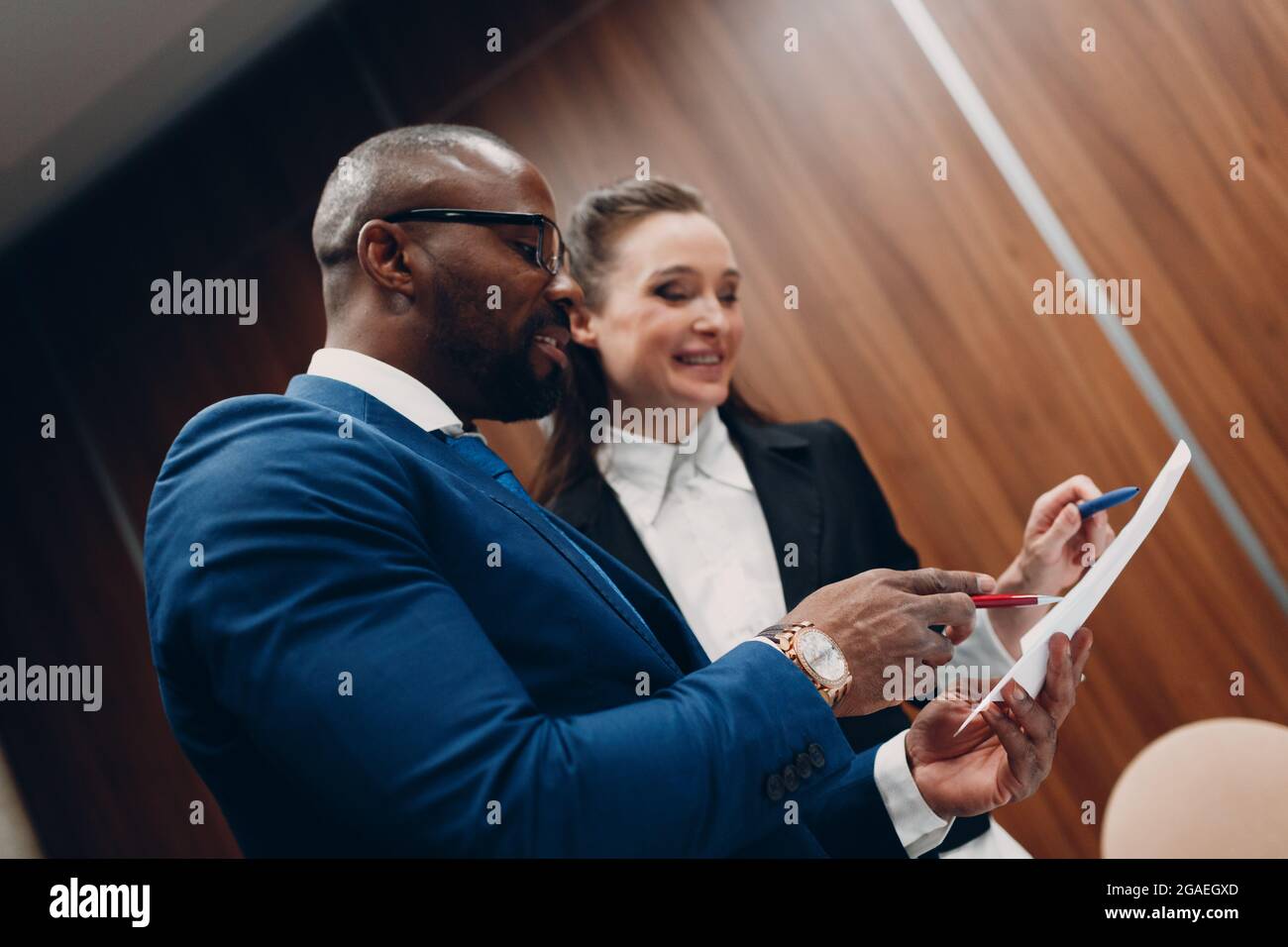 Businessman and businesswoman accountant team showing graph chart at ...