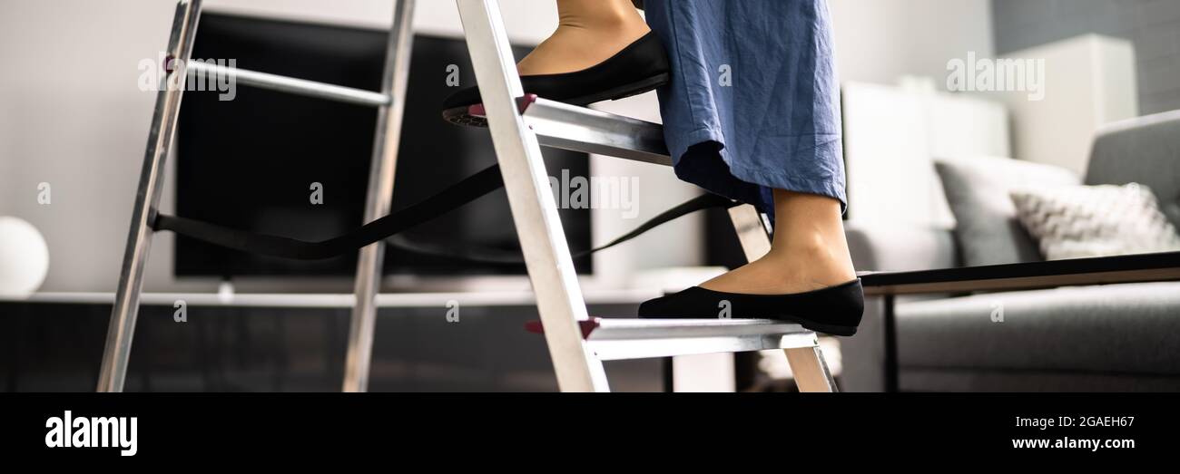 Ladder Safety. Woman Climbing Step Ladder In Shoes Stock Photo - Alamy