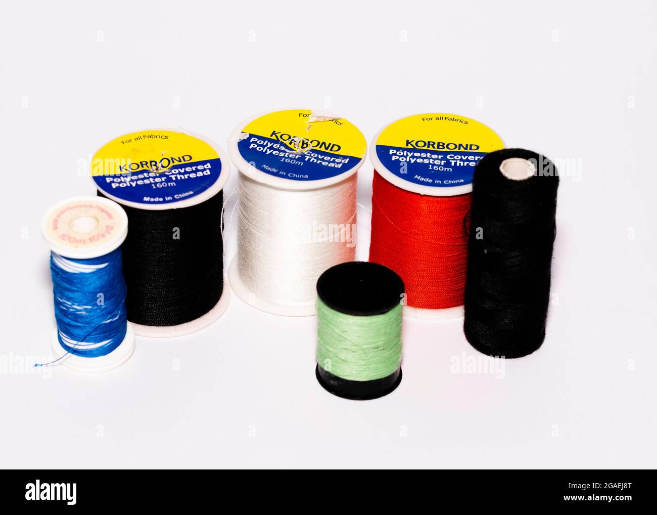 An assortment of coloured cotton on reels on a white background Stock ...
