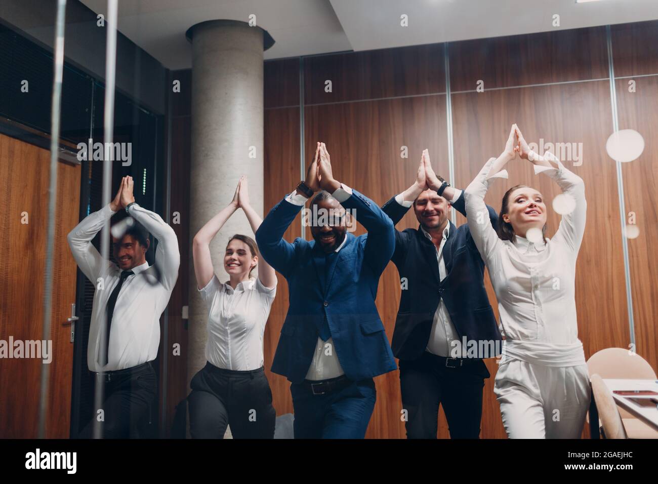 Businessman and businesswoman team doing warm-up and yoga exercises ...