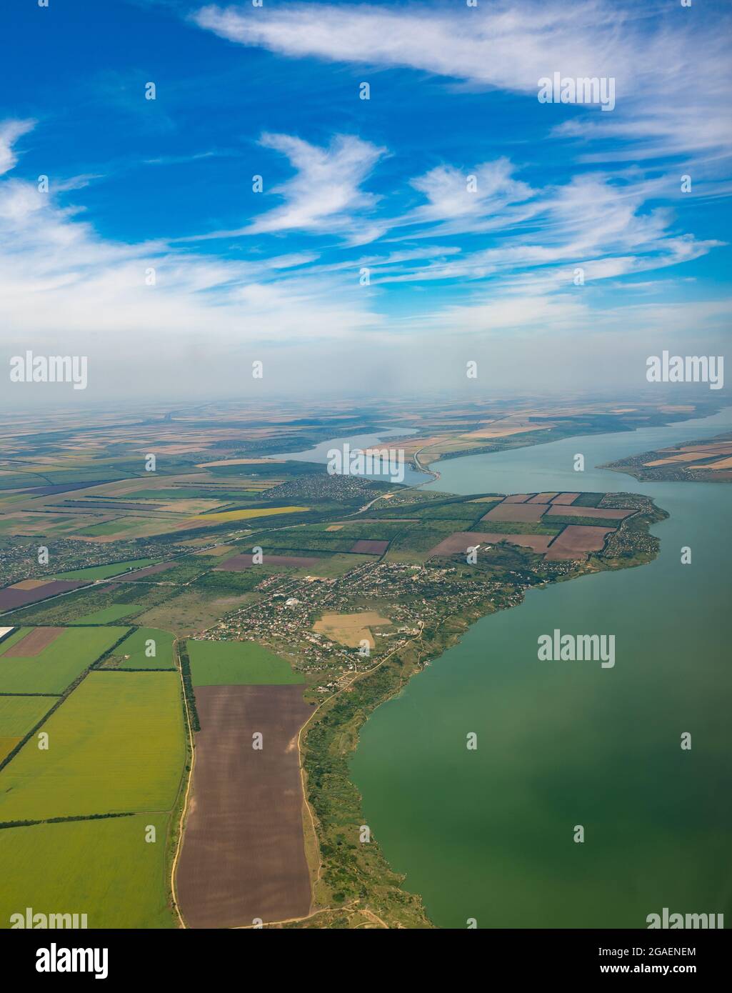 Land view through the airplane window. Fields, roads, rivers from a ...