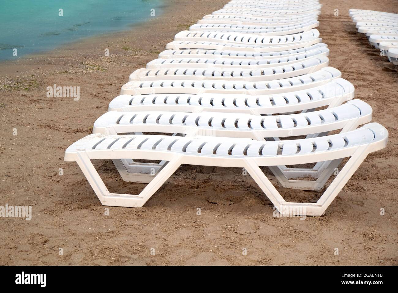 Sunbeds on sea beach at the resort Stock Photo - Alamy