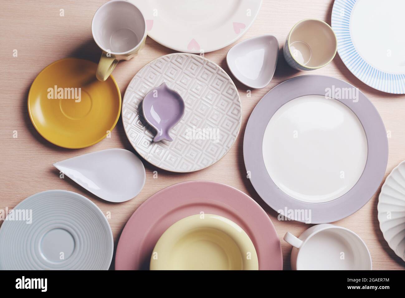 Set of colour plates on rose background Stock Photo - Alamy