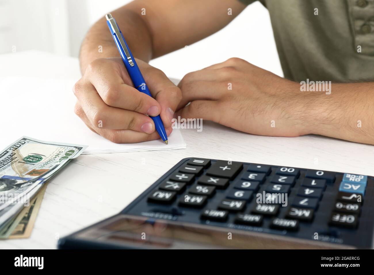 Calculating money, close up Stock Photo - Alamy